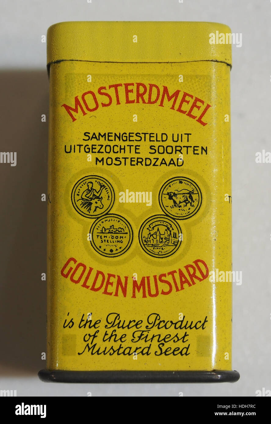 This image shows an old golden mustard tin, once used for storing ...