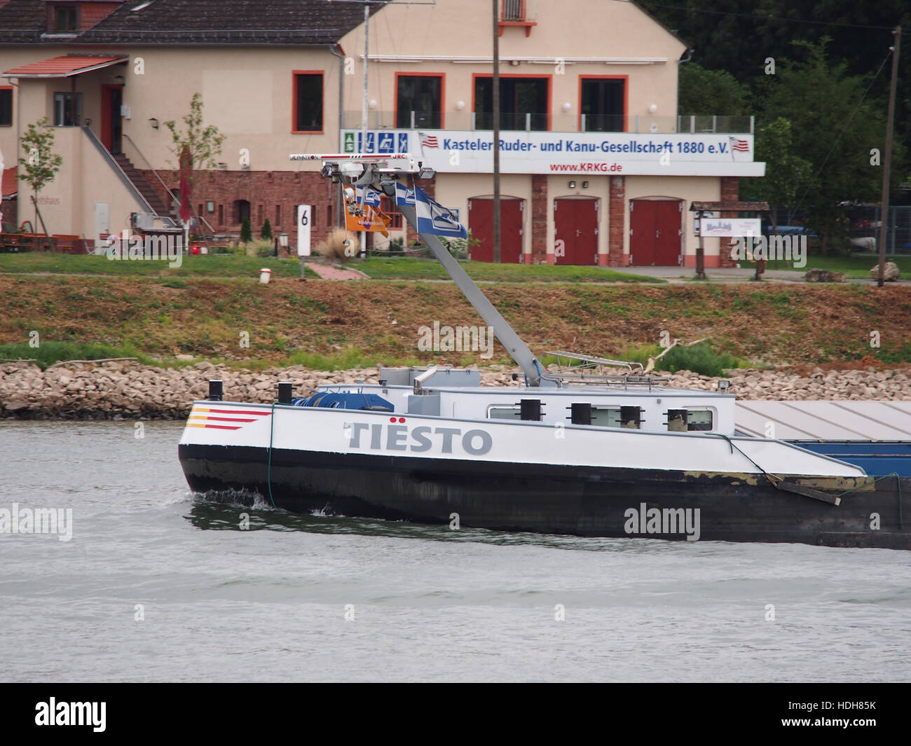 A photograph of the *Tiësto* ship, a modern vessel sailing on the Rhine ...