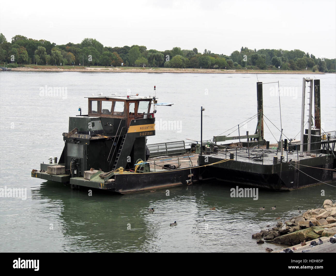This historical image shows a boat on the Rhine River at Mainz, with ...