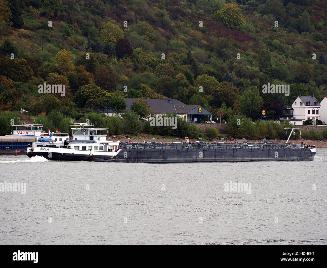 This photograph depicts the Imola, a modern ship, navigating the Rhine ...