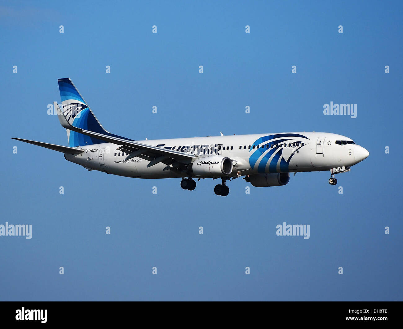 This image captures an aeroplane soaring high in the sky with its wings ...