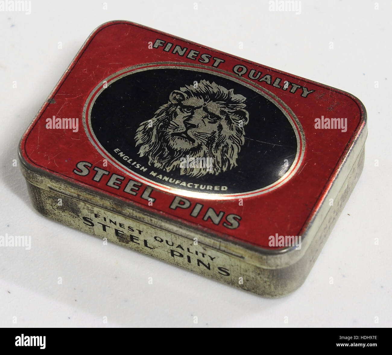An old tin storage container labeled 'Steel Pins Finest Quality,' used ...