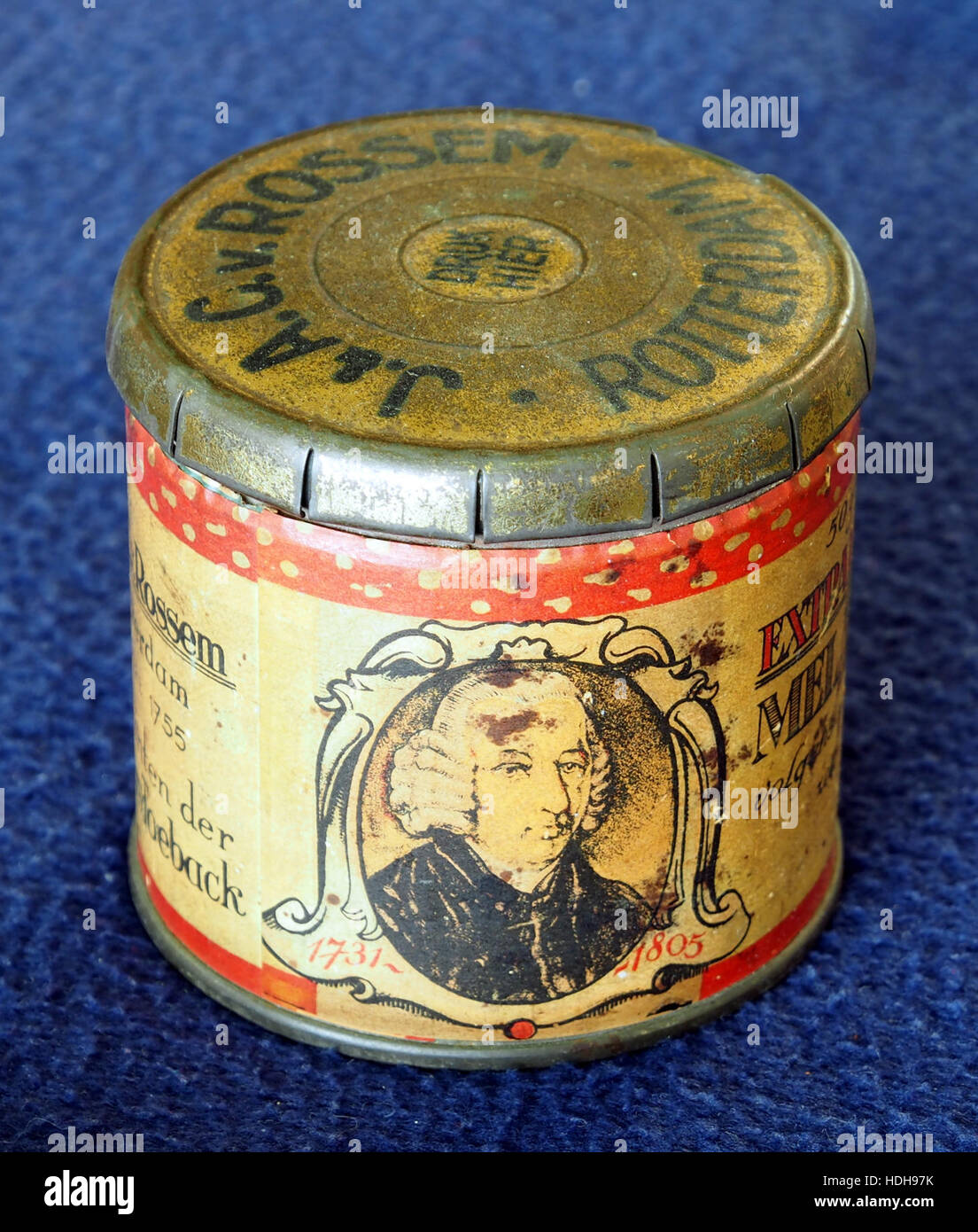 This image features an old tin container, commonly used in the past for ...
