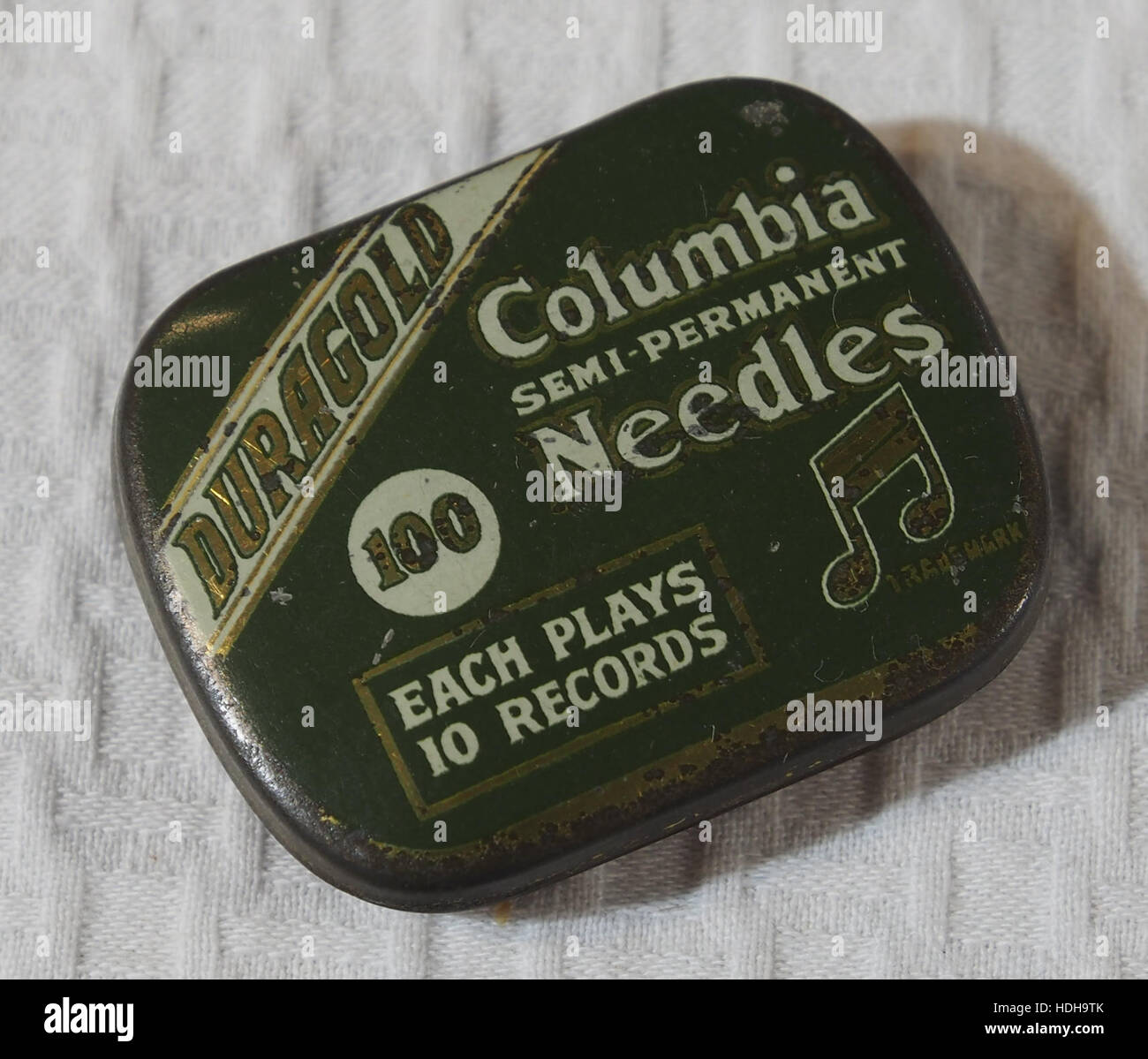An old tin container, labeled 'Columbia Needles,' once used for storing ...