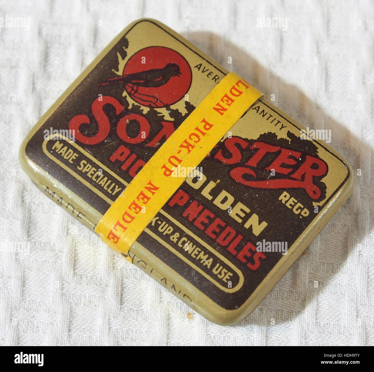 This image depicts an old tin container, originally used for storing ...