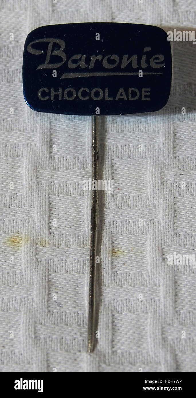 An advertisement pin from Baronie, an old promotional item from the ...