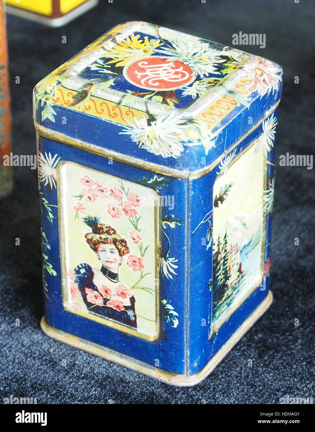 This image shows a blue tea tin, a collectible item often used for ...