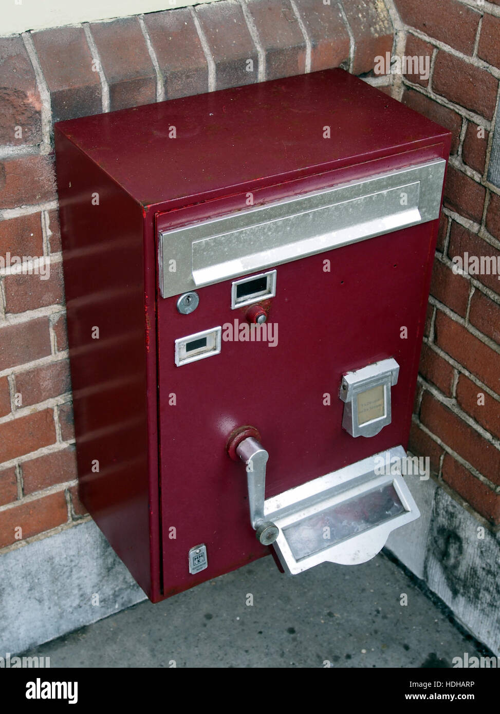 This image features an antique postzegel automaat, or stamp machine ...