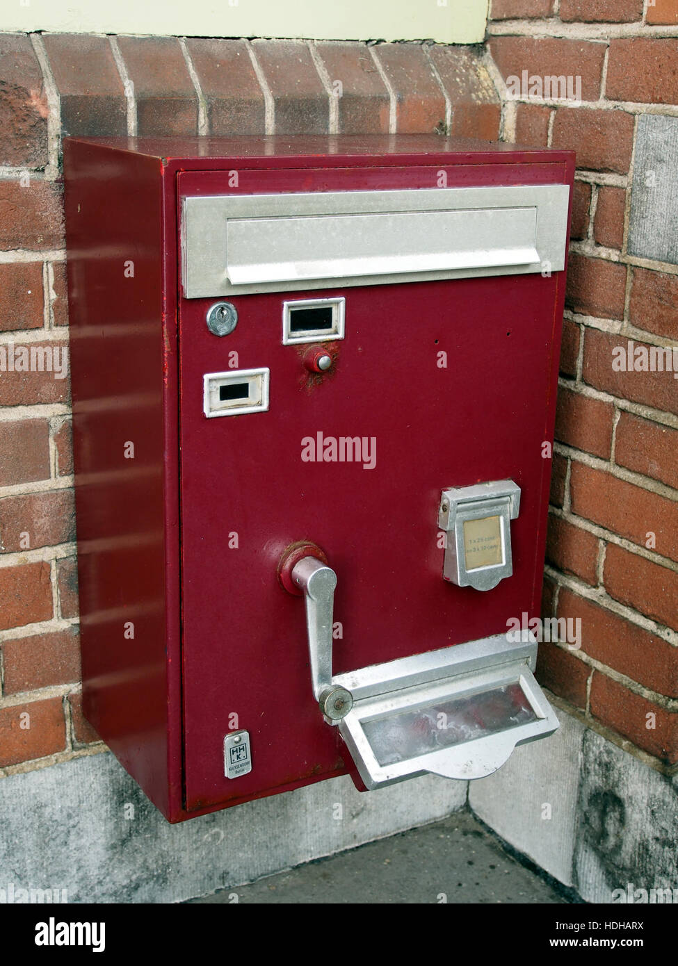 This vintage image showcases an old postage stamp machine, a relic from ...