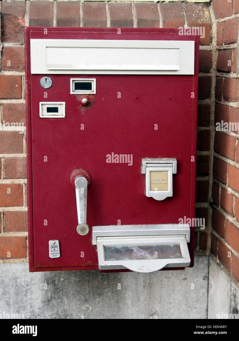 This image shows a vintage post office stamp machine, a historical ...
