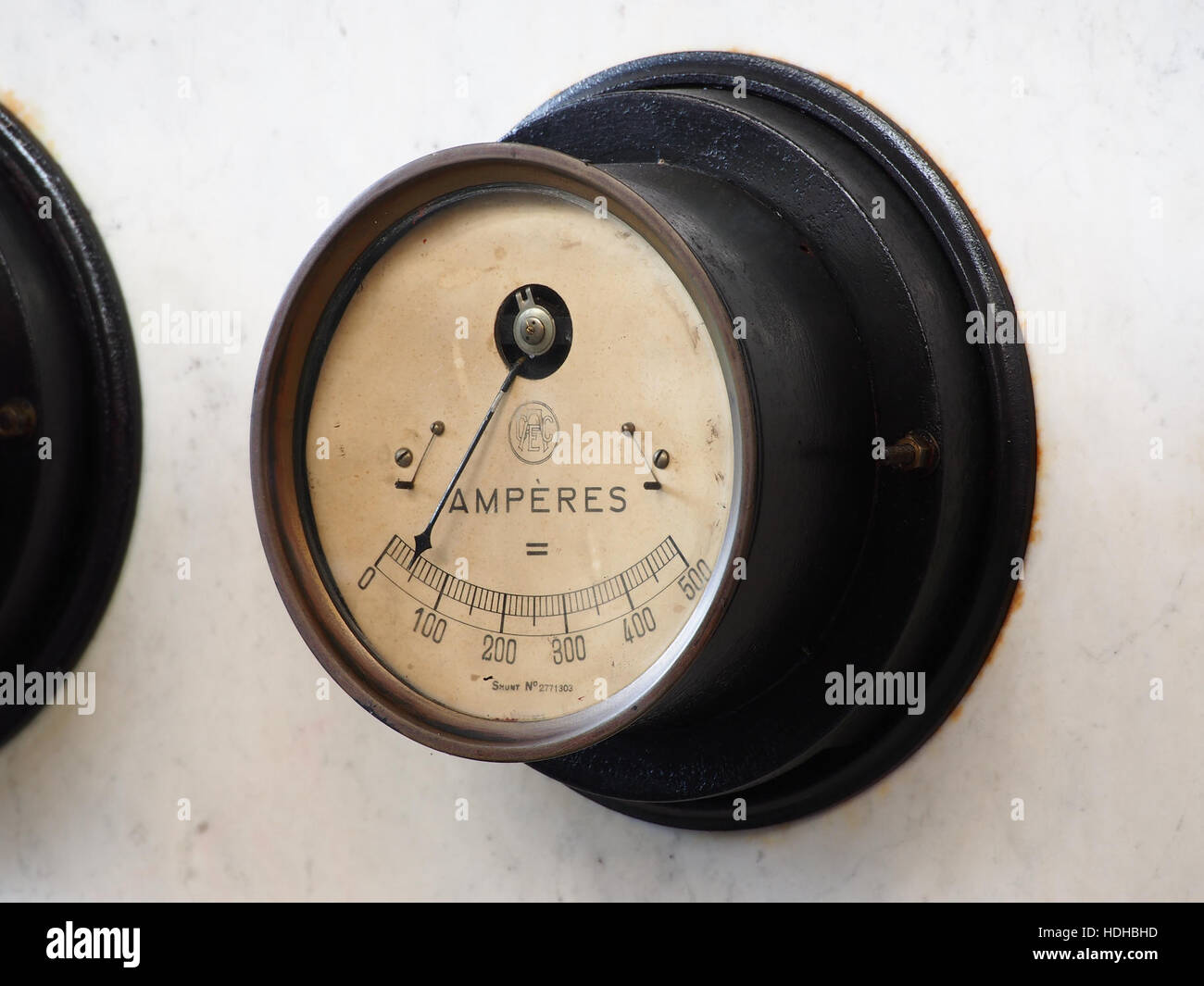 This image shows an antique Ampere meter displayed in a museum. The ...