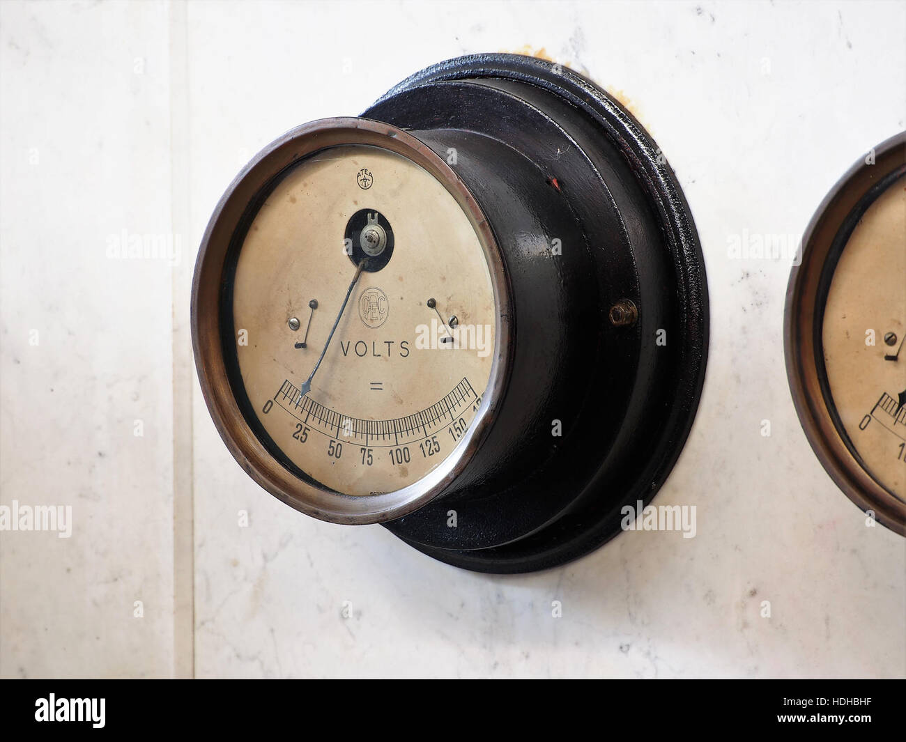 This image shows an antique volt meter, likely part of a collection ...