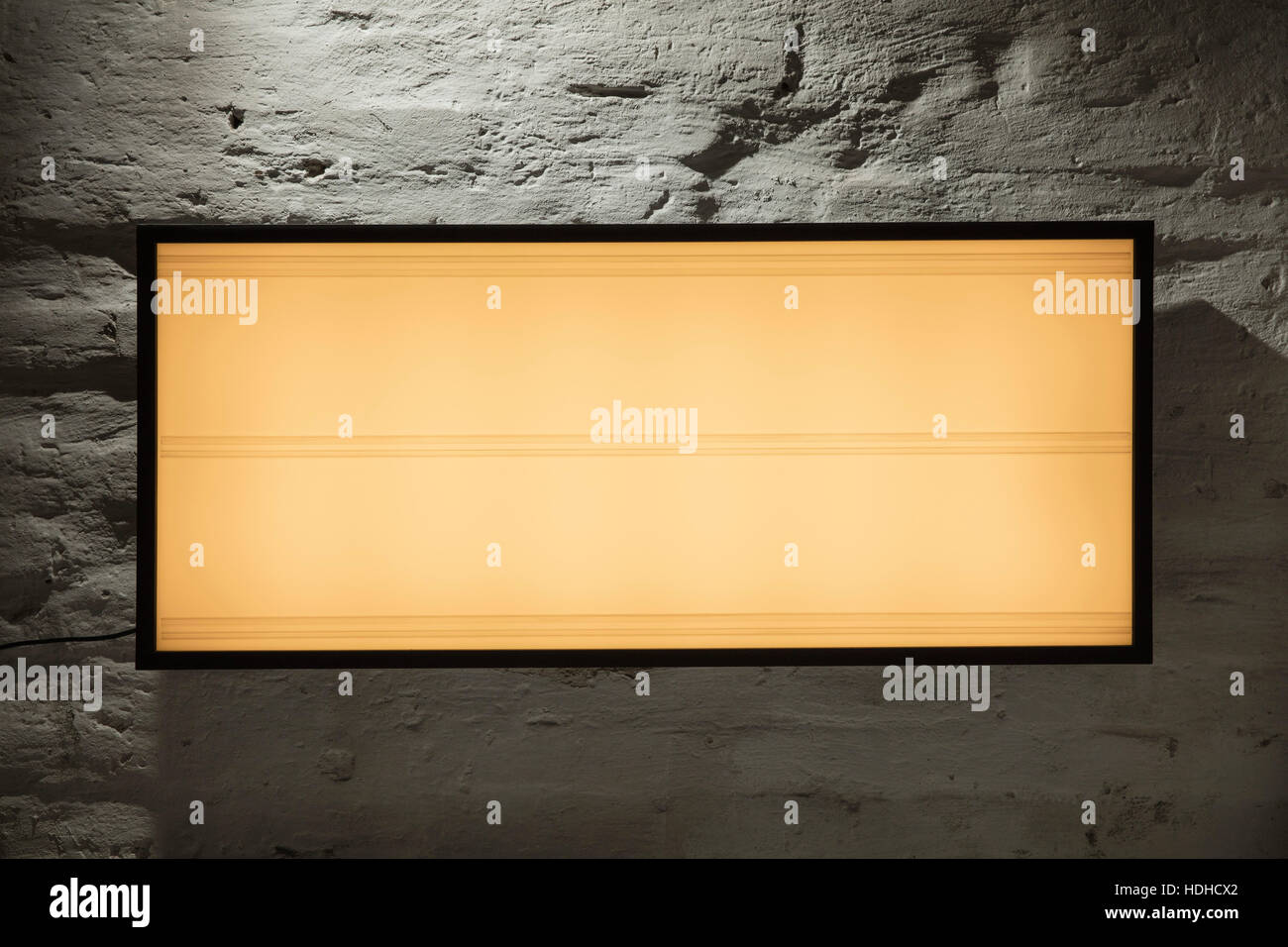 Close-up of blank illuminated signboard against gray wall Stock Photo ...