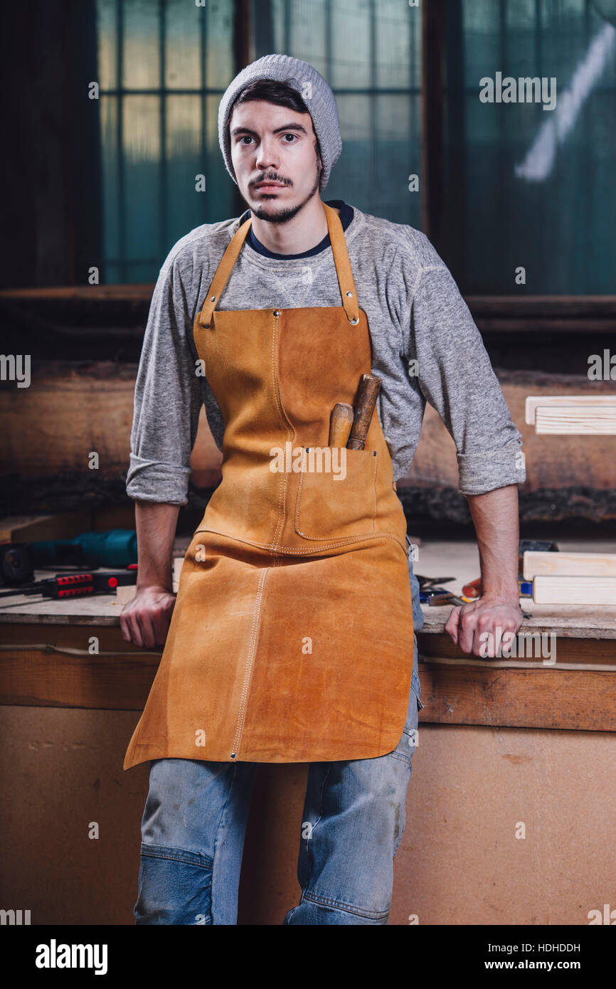 Portrait of carpenter sitting on bench at workshop Stock Photo - Alamy