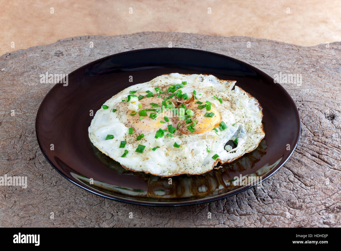 Fried eggs with double yolks sprinkle with pepper and Spring onion ...