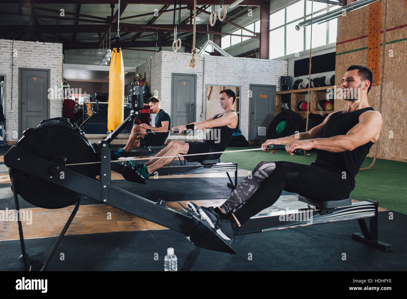 Three young men pulling hi-res stock photography and images - Alamy