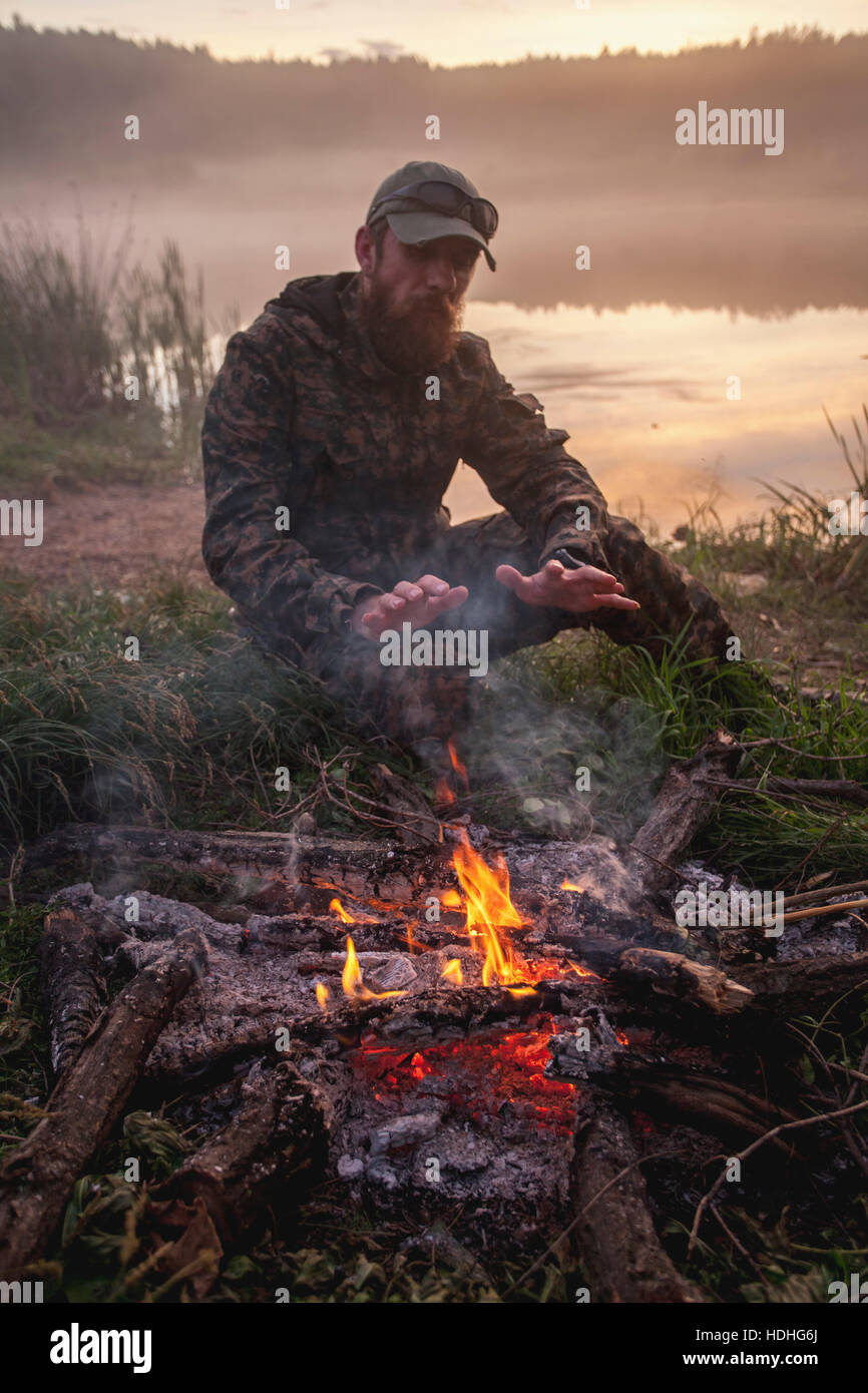 Person warming hands on burning hi-res stock photography and images - Alamy