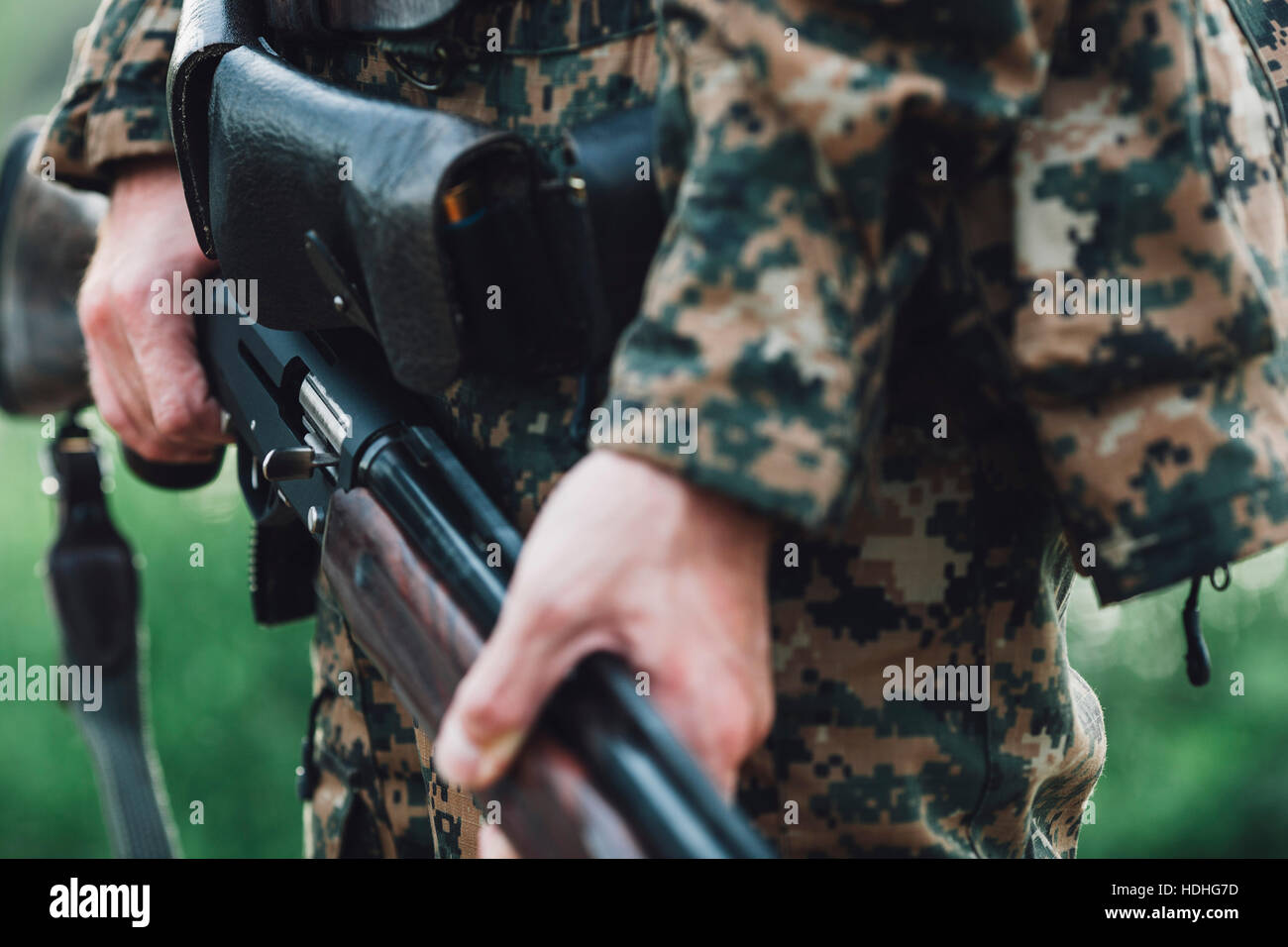 Midsection of hunter holding rifle Stock Photo - Alamy