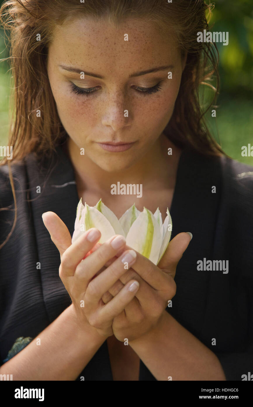 Beautiful young woman holding flower hi-res stock photography and ...