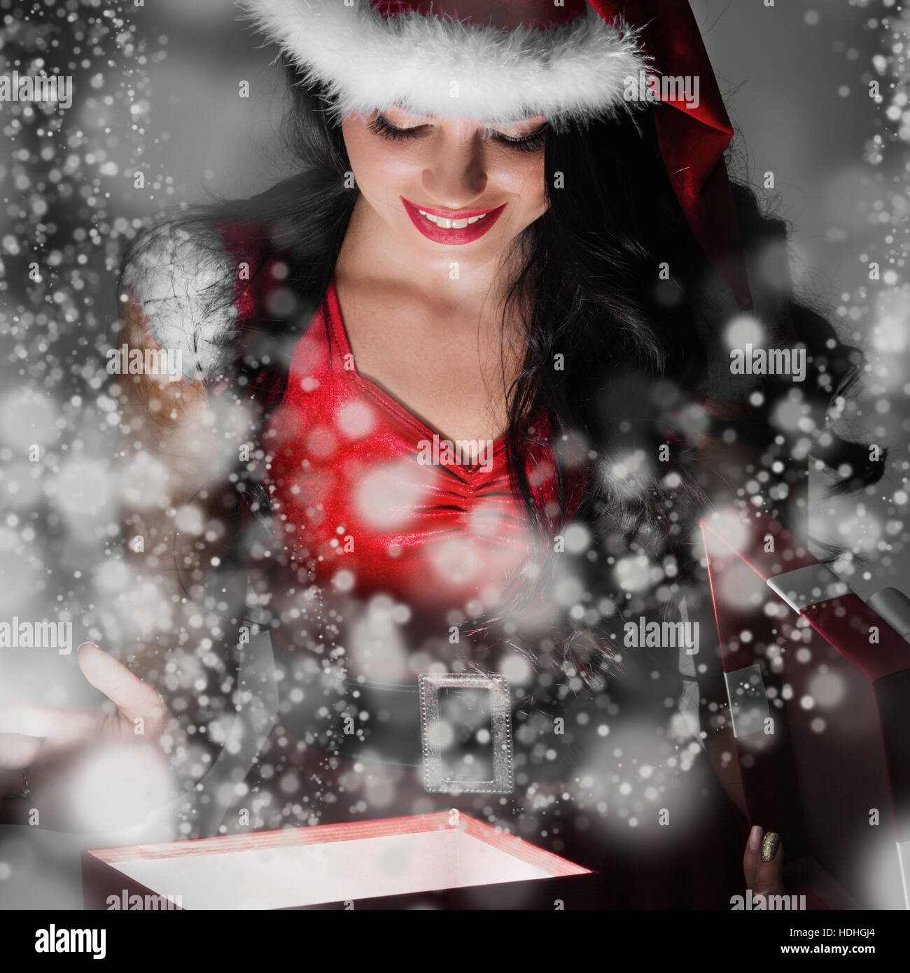 Beautiful Santa girl opening the magical Christmas present box Stock ...