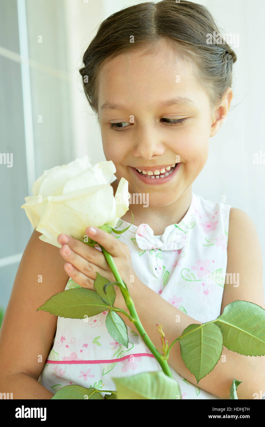 Little girl with rose flower Stock Photo - Alamy