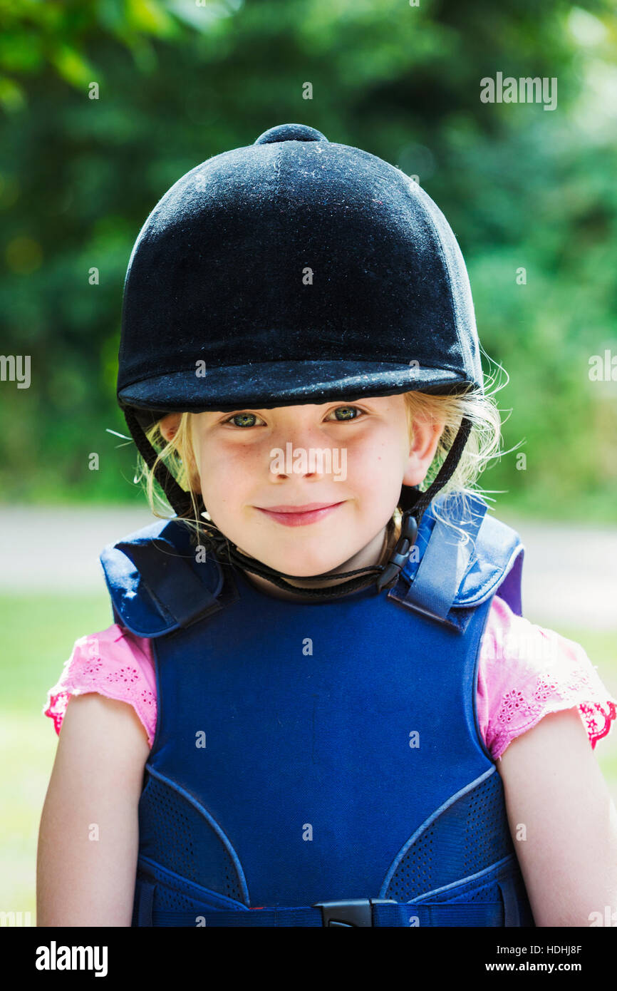 Portrait of blond girl wearing riding hat Stock Photo - Alamy
