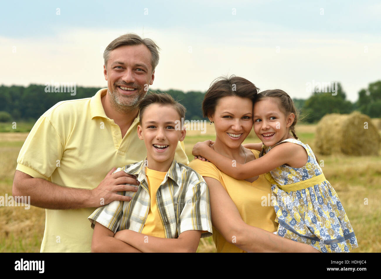 happy family at field Stock Photo - Alamy