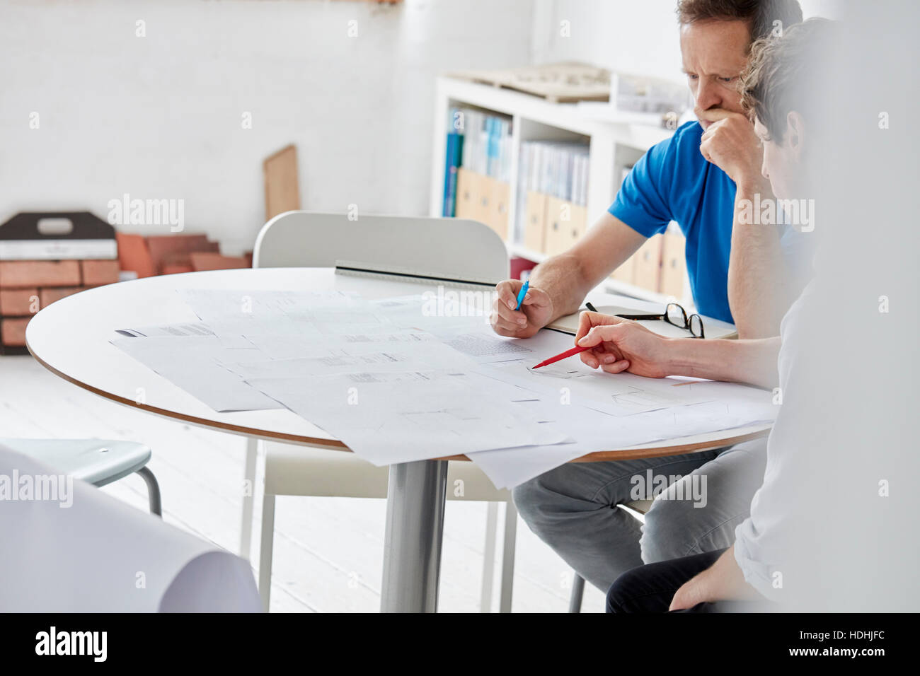 Male architects discussing plans using hi-res stock photography and ...