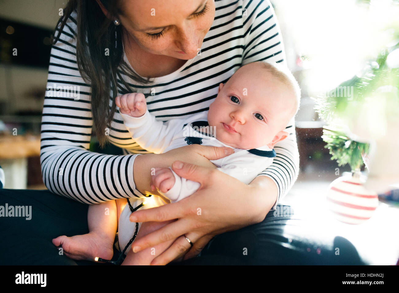 Beautiful young mother holding her baby son in her arms Stock Photo - Alamy Beautiful young mother holding her baby son in her arms Stock Photo - Alamy