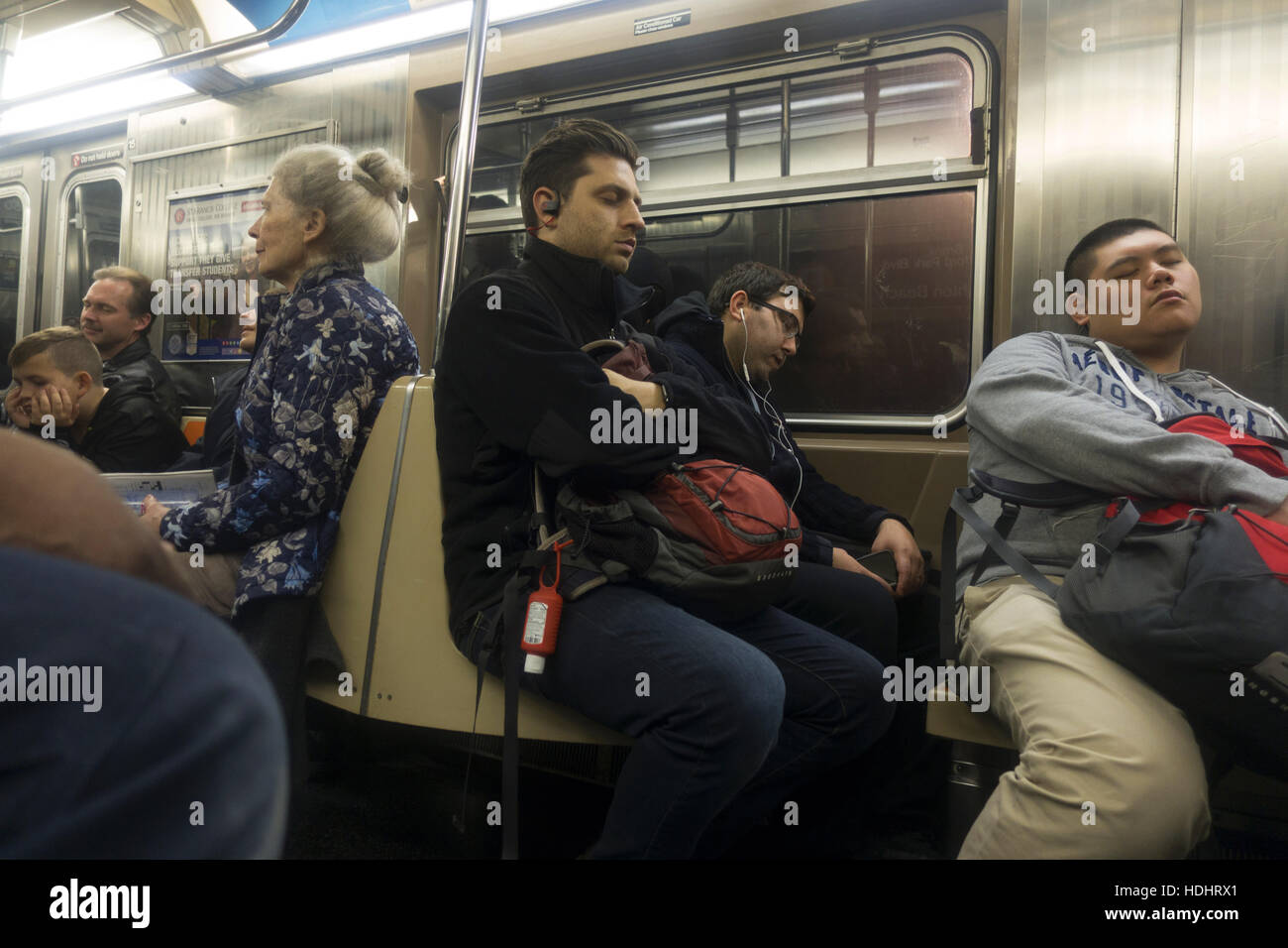 Tired riders on a New York City subway train at rush hour Stock Photo ...