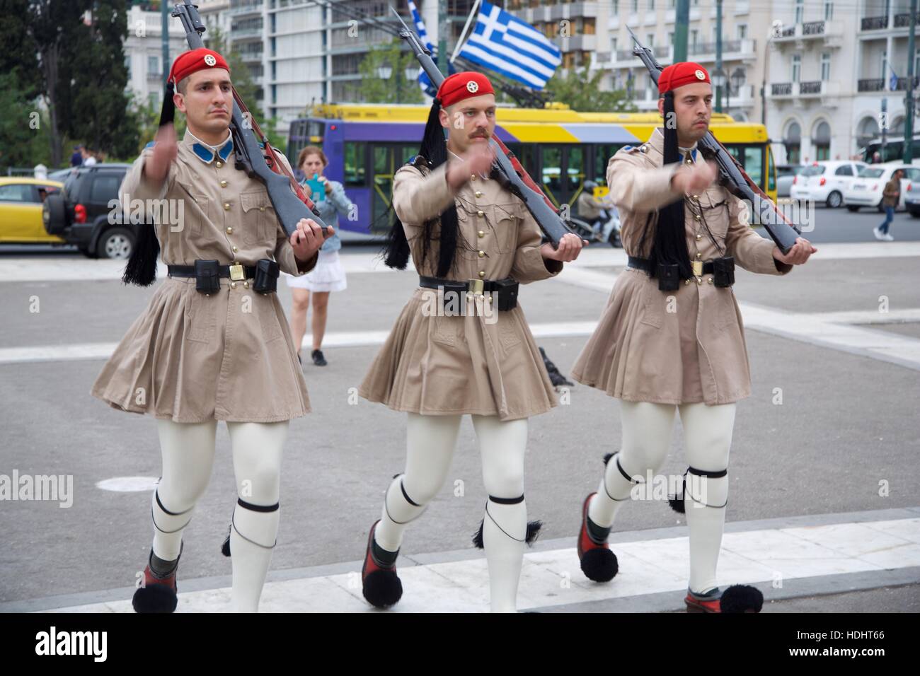 An officer and two guards approach to change the guards in Athens Stock ...