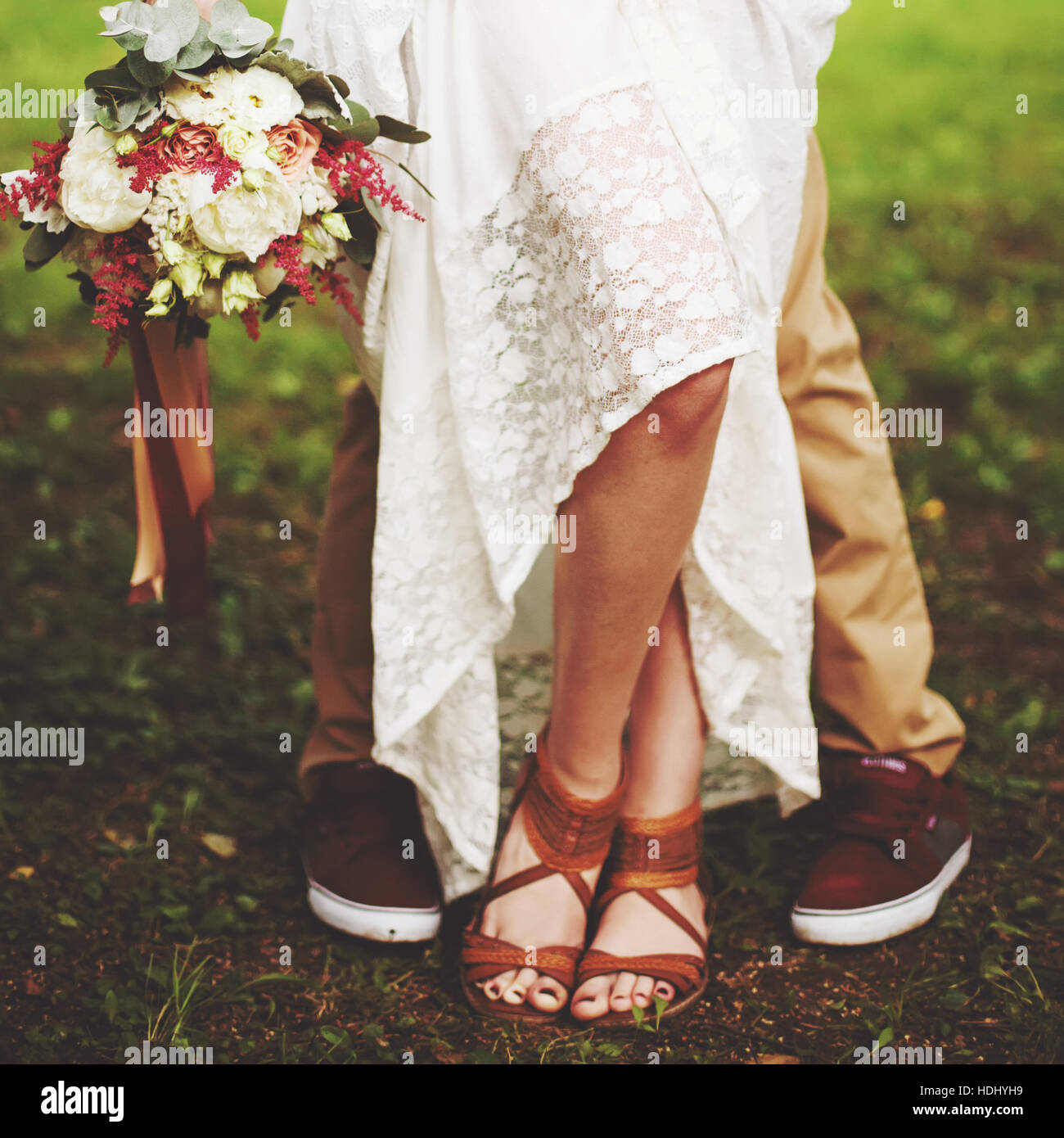 Boho chic style. Legs of wedding couple close-up, freedom concept ...
