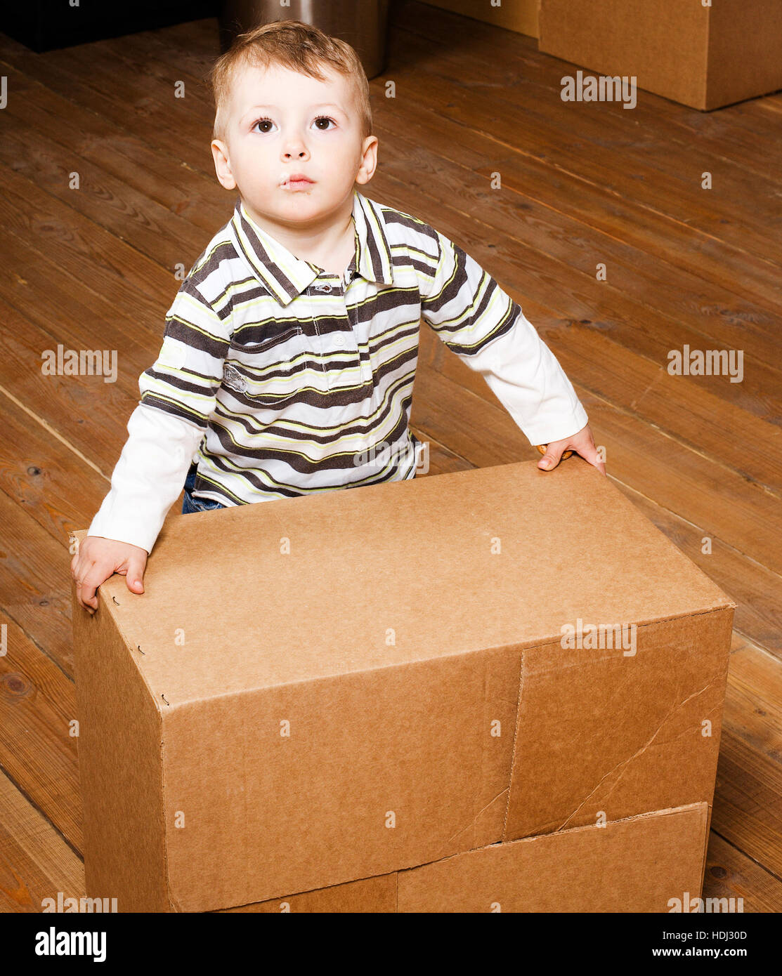 portrait of little cute boy playing with box, lifestyle people concept ...
