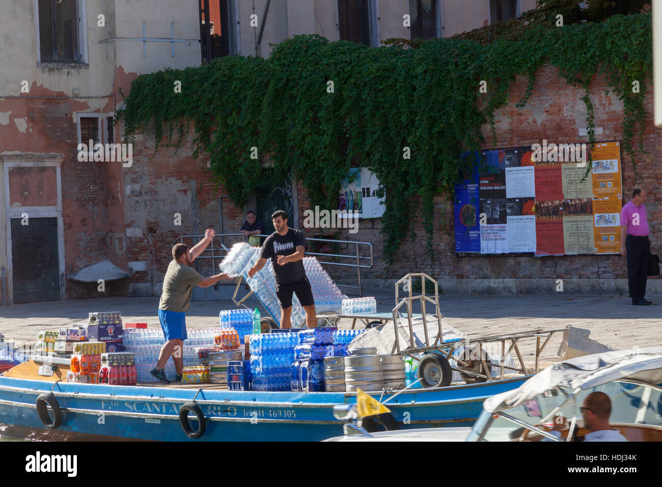Unloading cargo of drinking water Stock Photo - Alamy