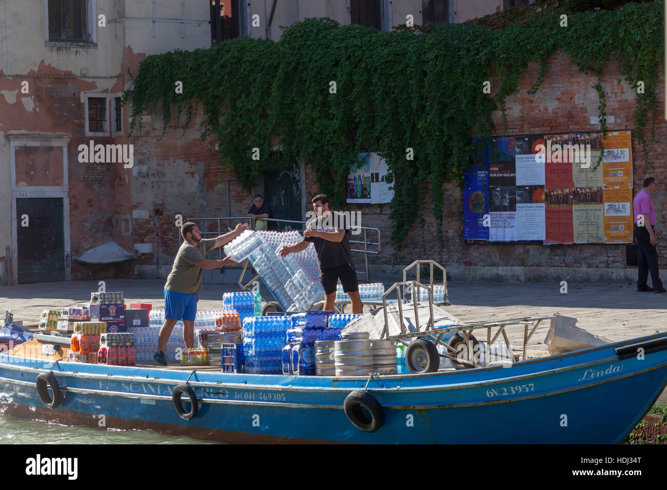 Unloading cargo of drinking water Stock Photo - Alamy