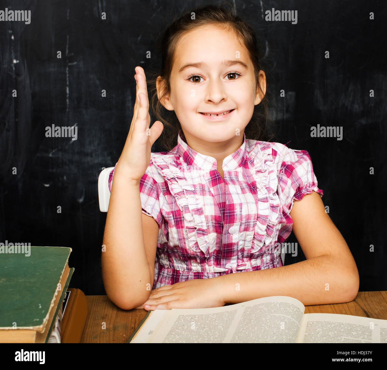 cute little real girl pupil in classroom at blackboard writting, girl ...