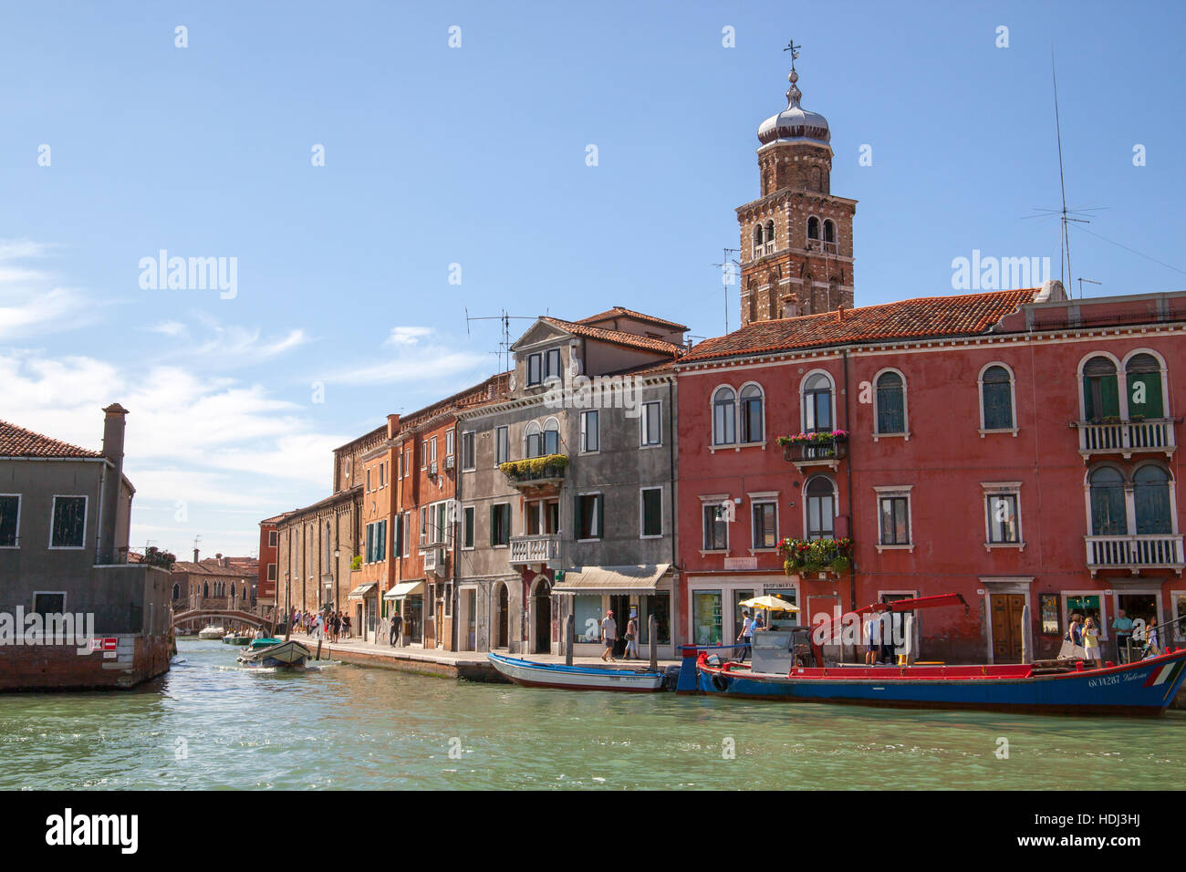 Vibrant building facades along tranquil canals in Murano island Stock ...
