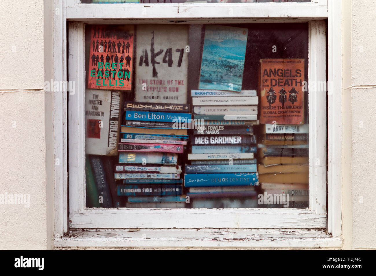 Pile of books in misty dirty window Stock Photo - Alamy