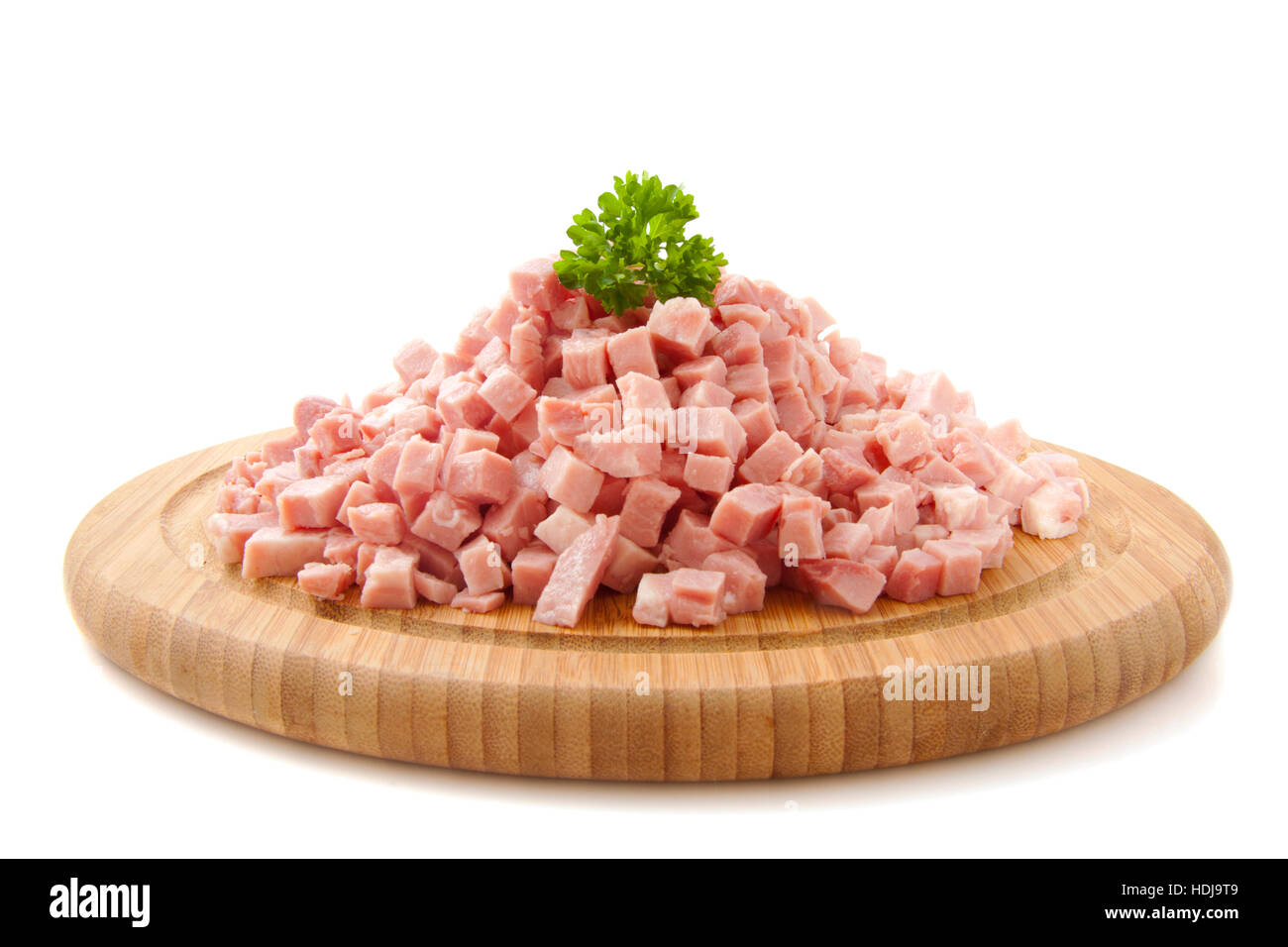 Pieces of chopped ham on wooden plate isolated over white Stock Photo ...