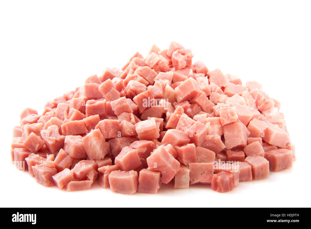 Pieces of chopped ham on a pile isolated over white Stock Photo - Alamy