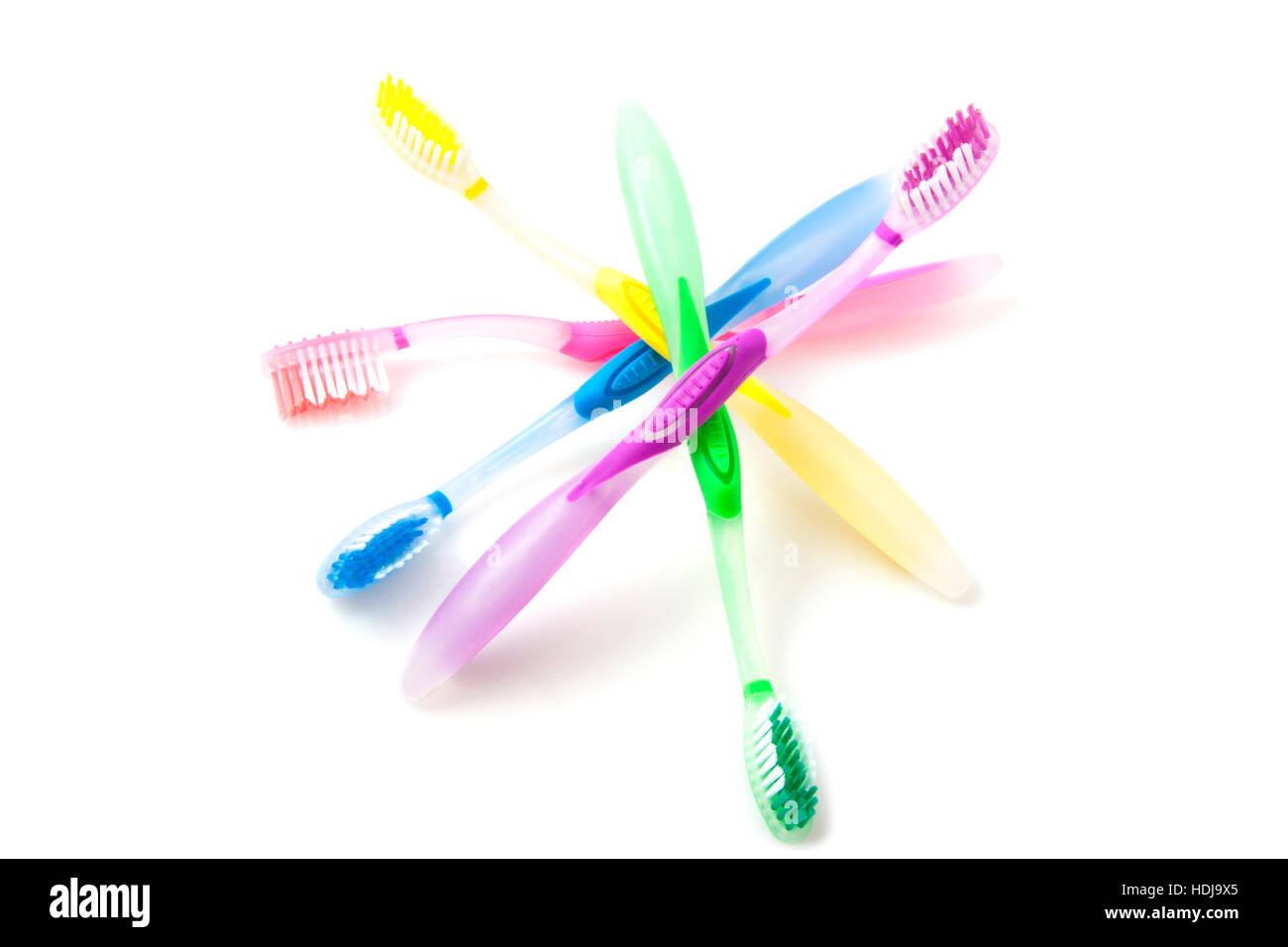 Colorful toothbrushes on a pile isolated over white Stock Photo - Alamy