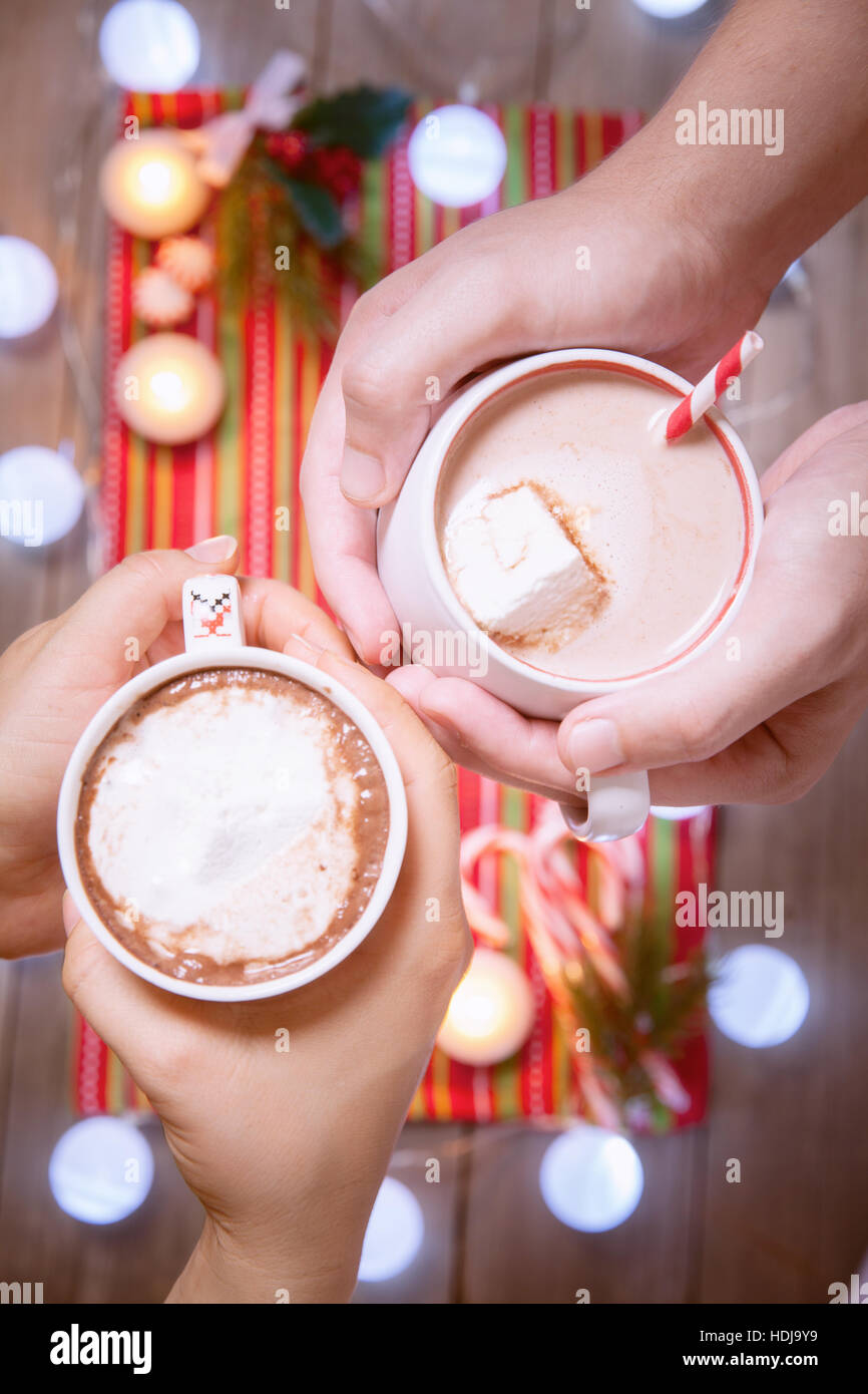 Two mugs in a hands with hot chocolate. Top view Stock Photo - Alamy