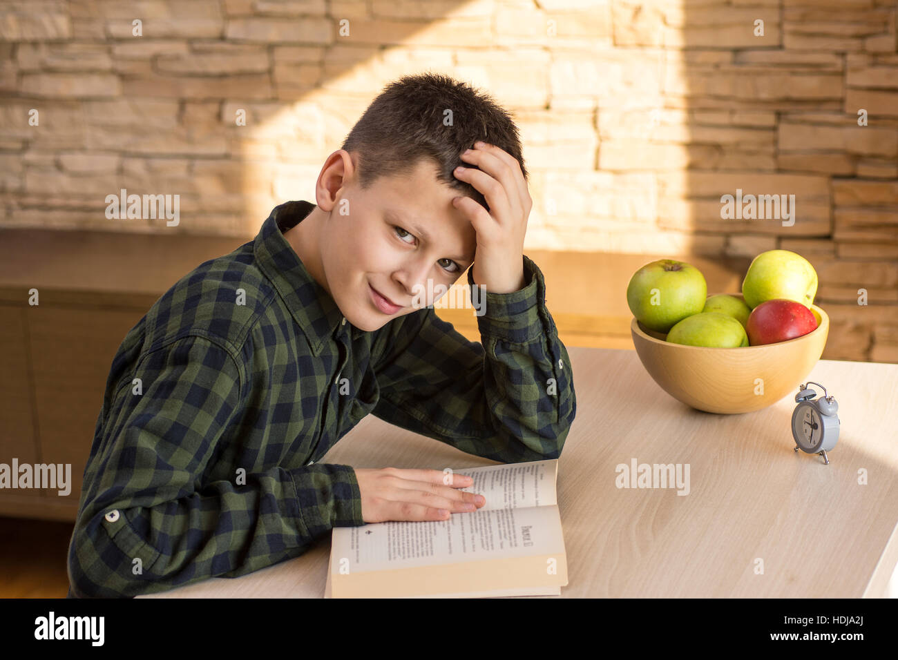 Young Boy Reading Book and Studying on Desk at Home Stock Photo - Alamy