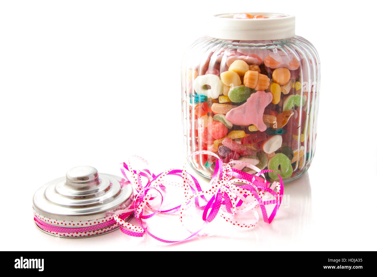 Jar filled with colorful candy isolated over white Stock Photo - Alamy