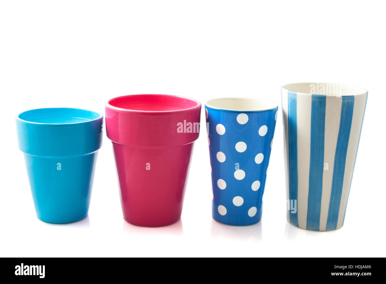 Four colorful pots in a row isolated over white Stock Photo - Alamy