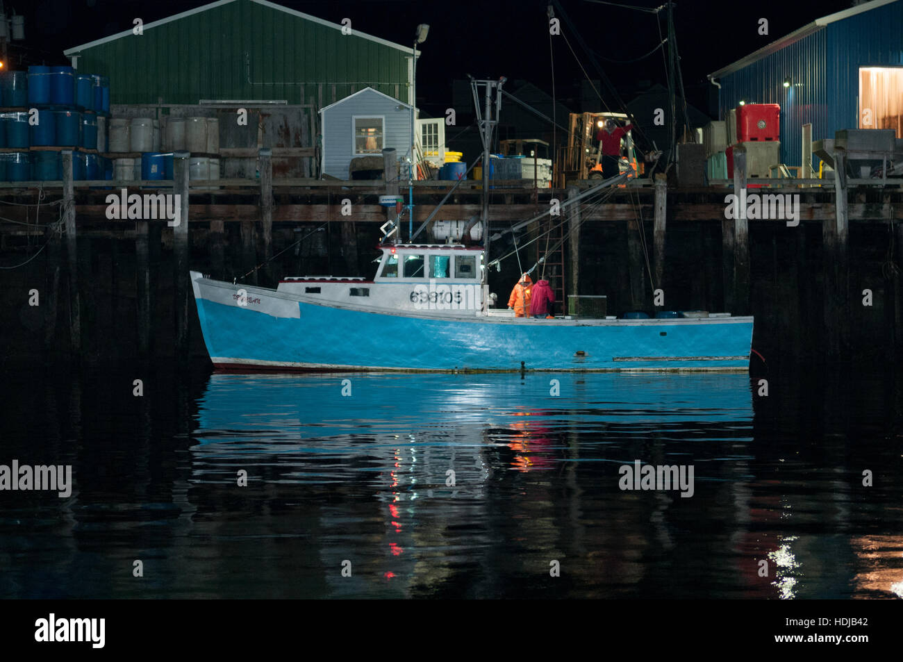 Lobster boat unloads catch late at night, Portland Stock Photo - Alamy