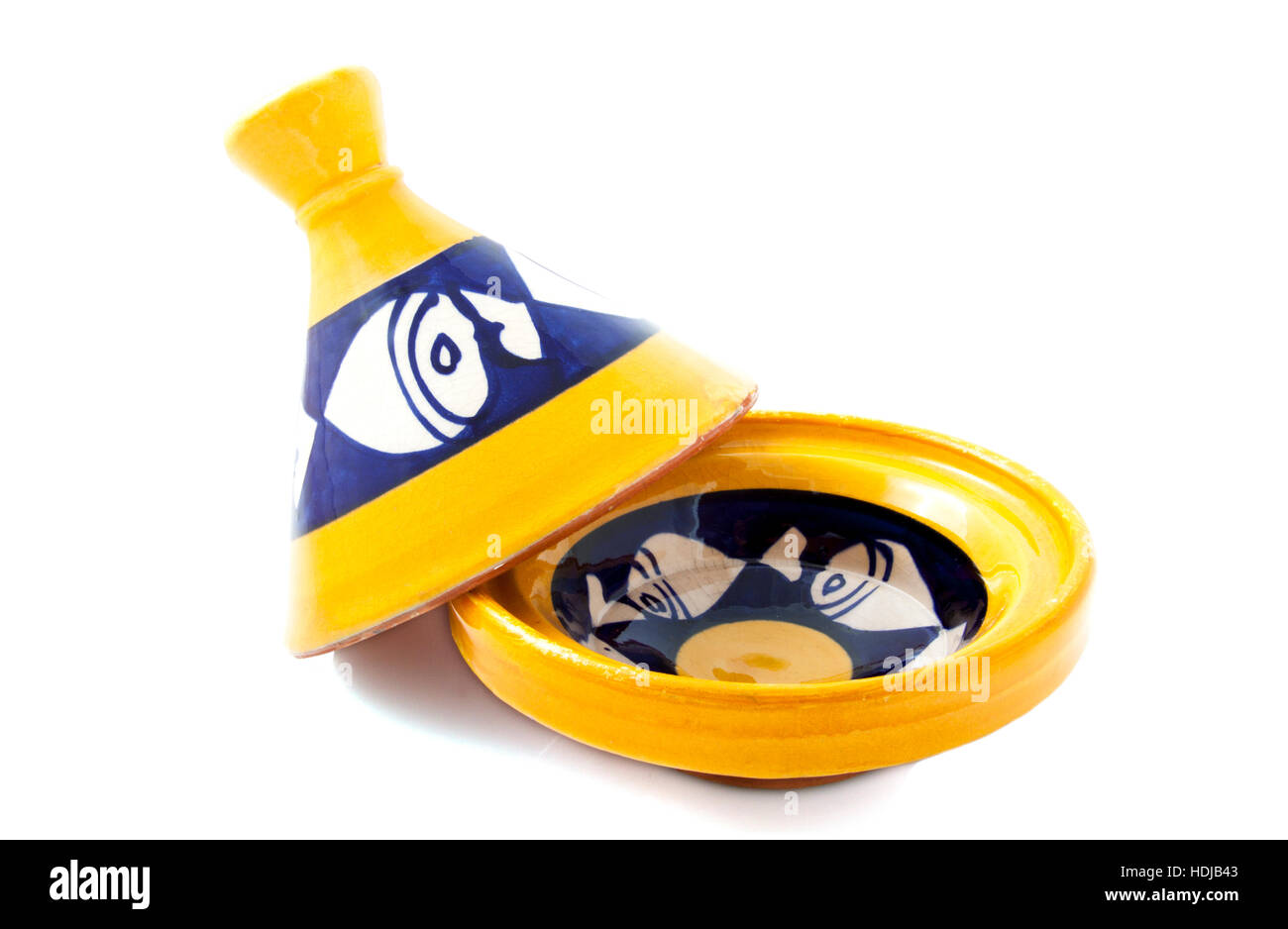 Handmade tajine with yellow and blue colors isolated over white Stock ...