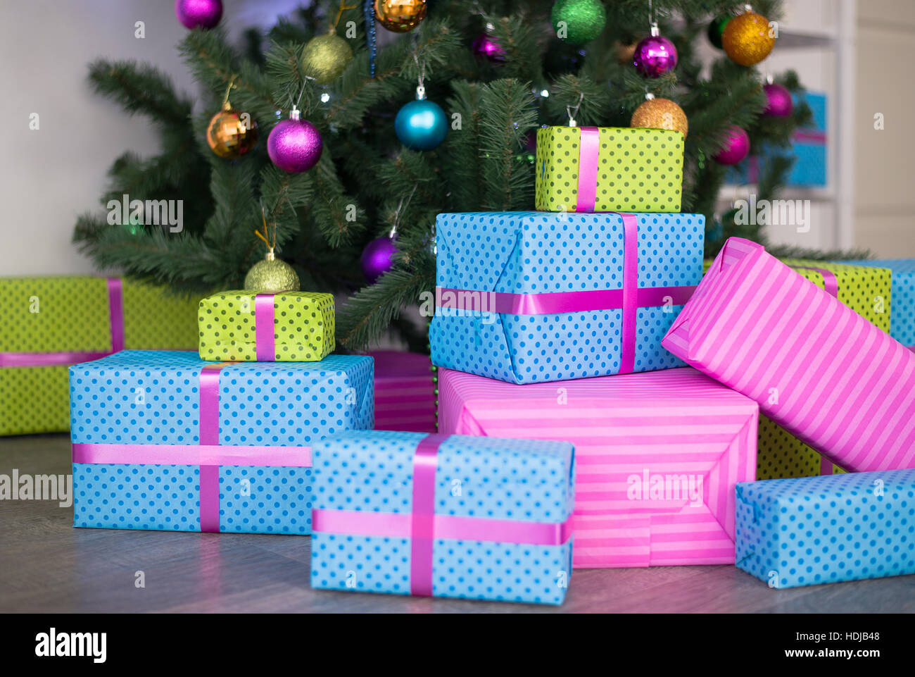 Boxes with Christmas gifts under the tree Stock Photo - Alamy