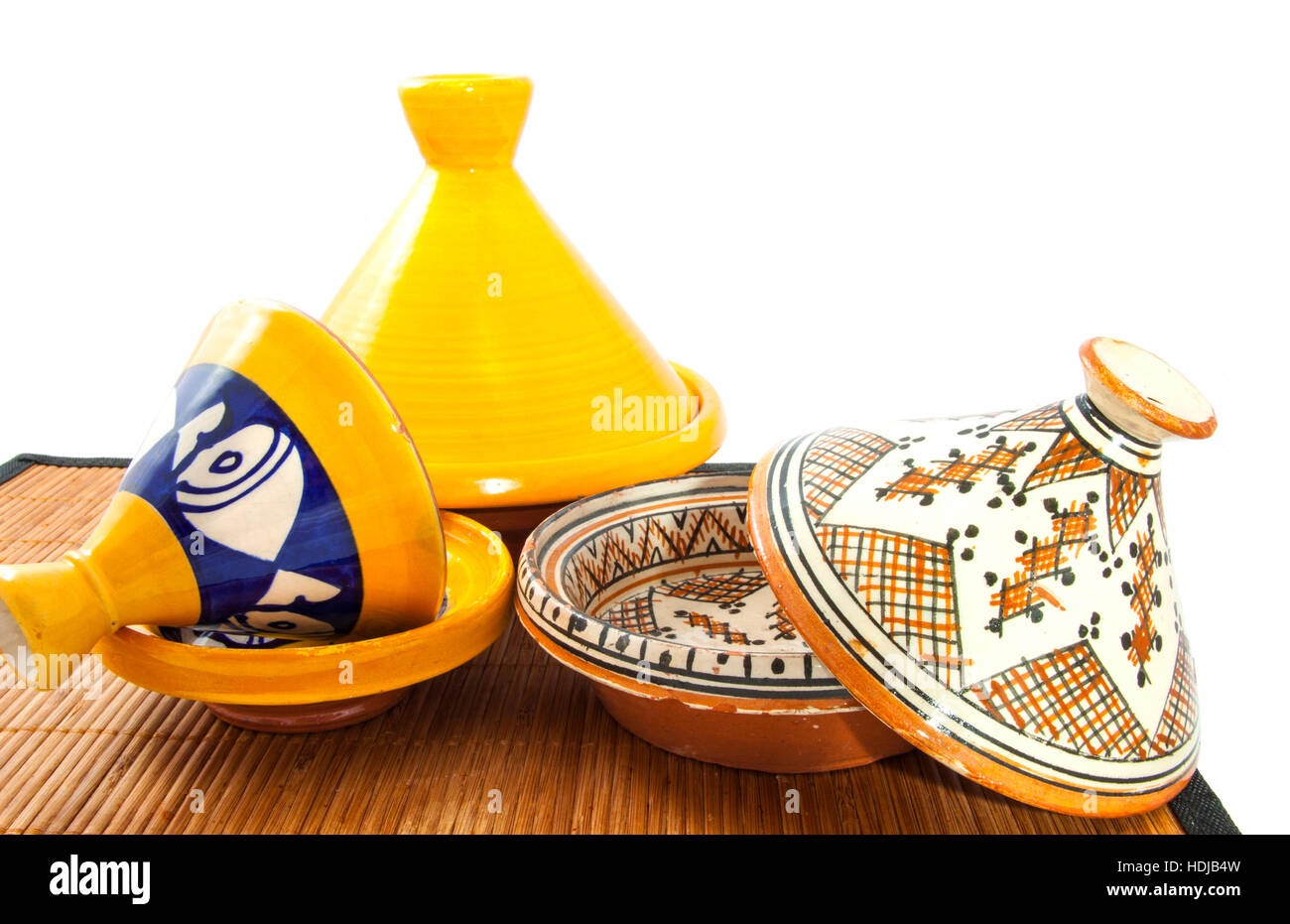 Three handmade ceramic cooking pots on wood Stock Photo - Alamy