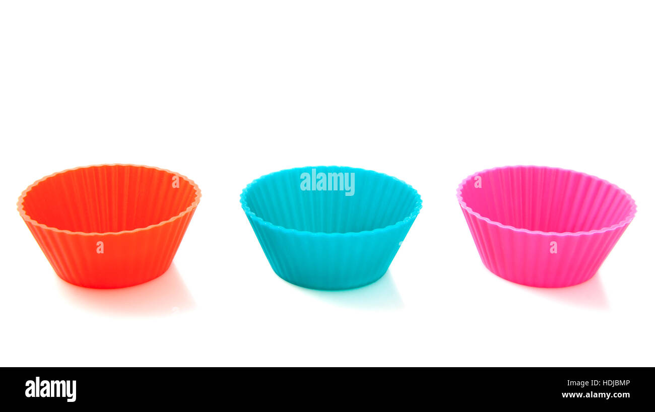 Three colorful cups in a row isolated over white Stock Photo - Alamy
